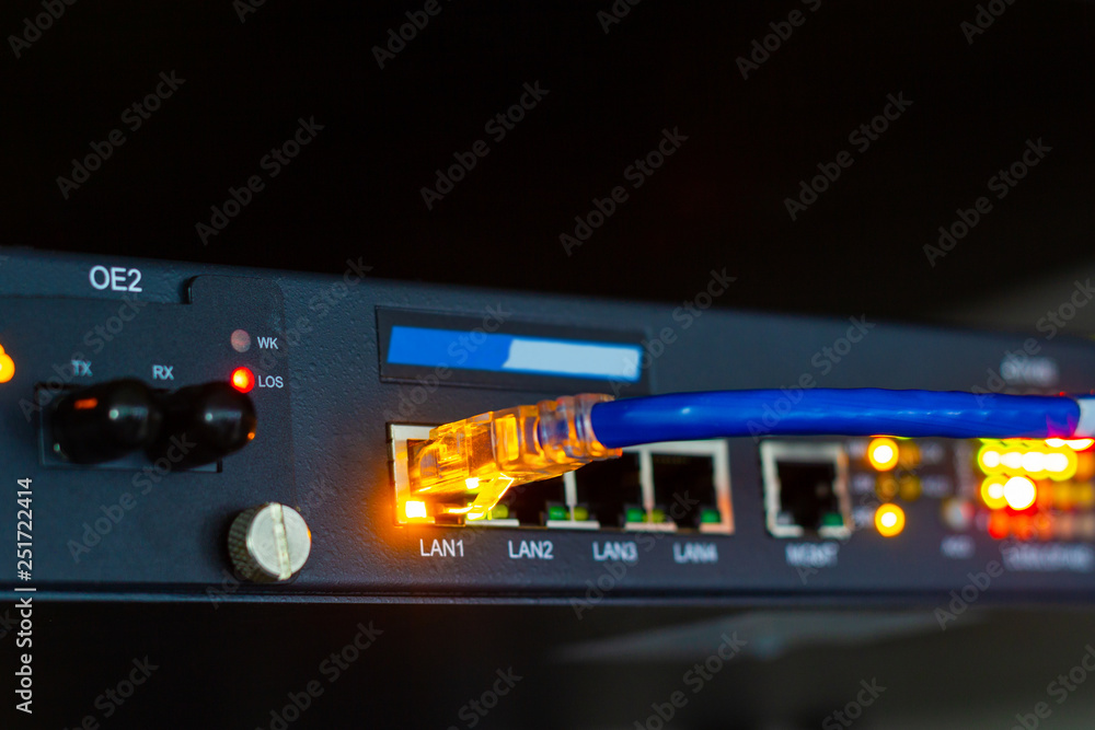 Network switch in rack, network cables connect SFP module port in the ...