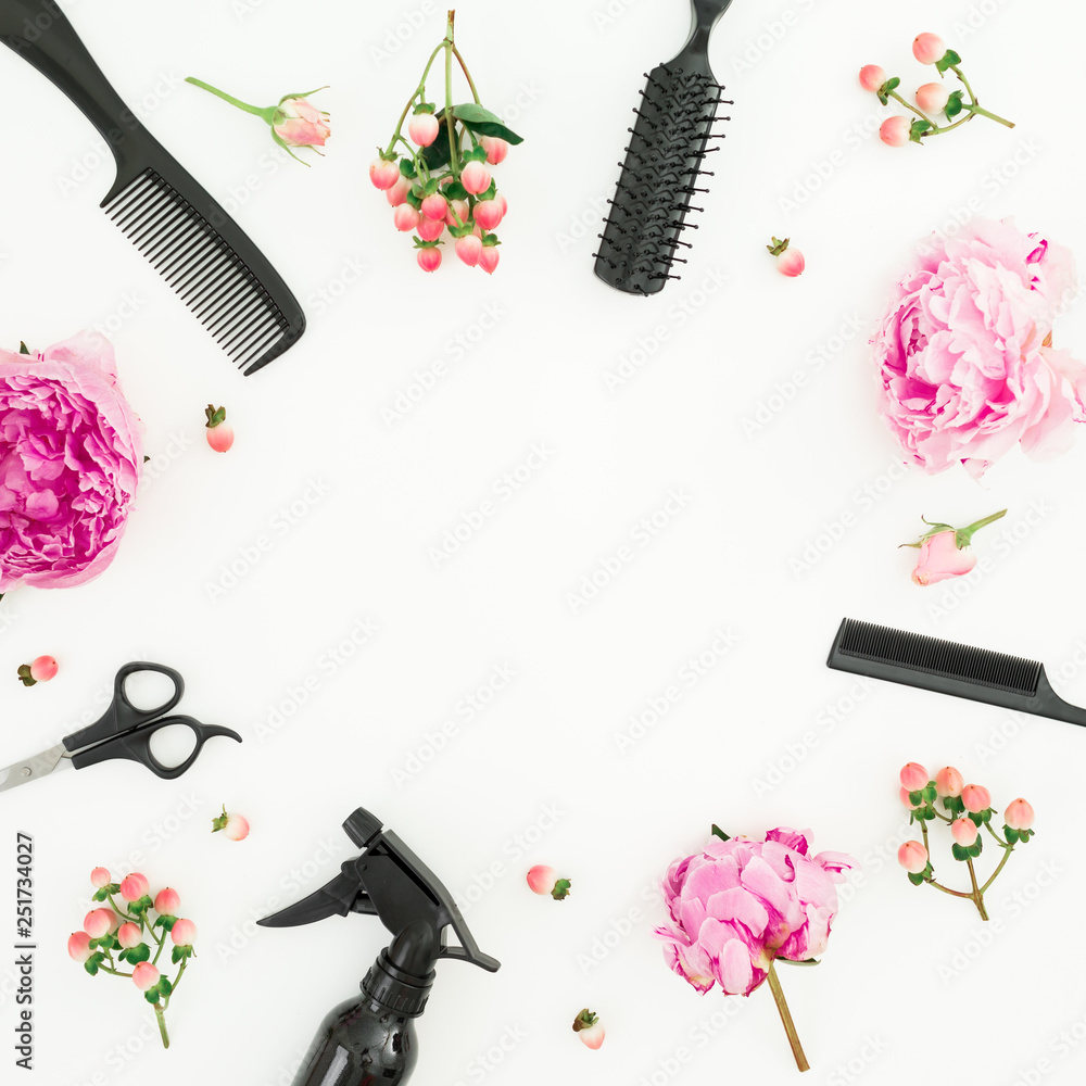 Hairdresser frame with spray, scissors, combs and peonies flowers on ...