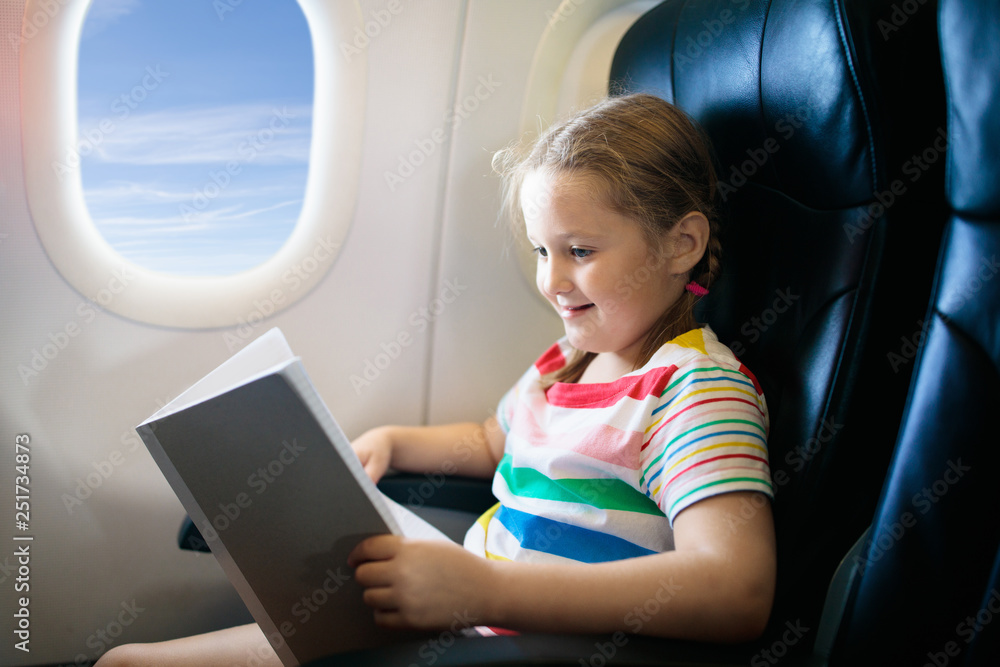 Child in airplane. Fly with family. Kids travel. Stock Photo | Adobe Stock