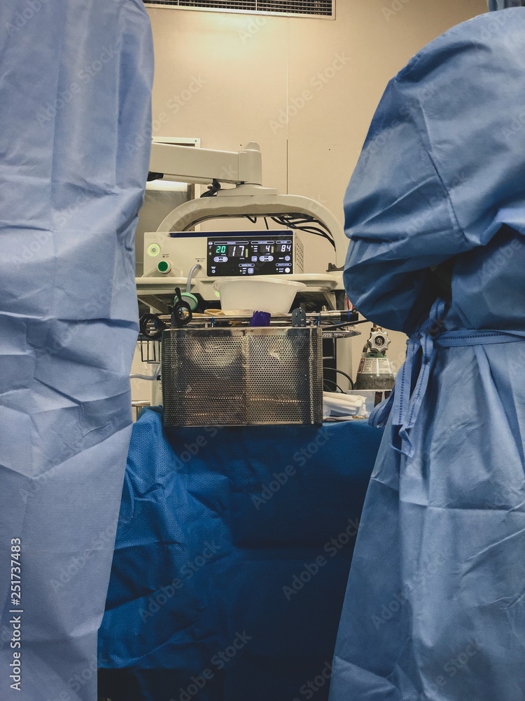 Surgeons using surgical instruments for keyhole surgery, watching the ...