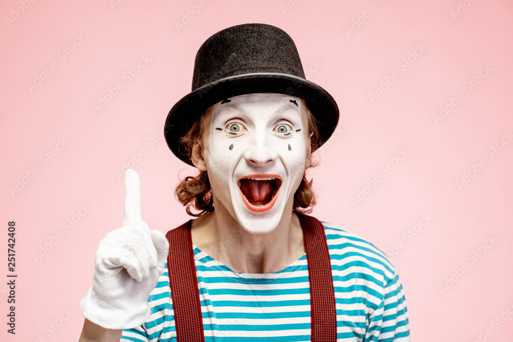 Portrait of an actor as a pantomime with white facial makeup posing ...