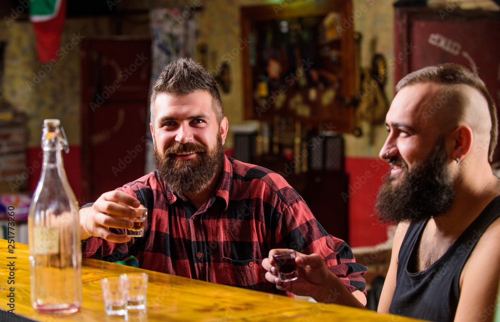 Strong alcohol drinks. Friends relaxing in pub. Men drinking alcohol ...