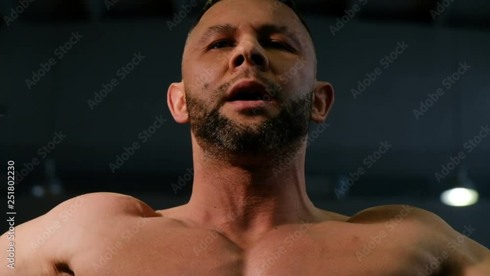 Weightlifter performs an exercise on the pectoral muscles, overcoming ...