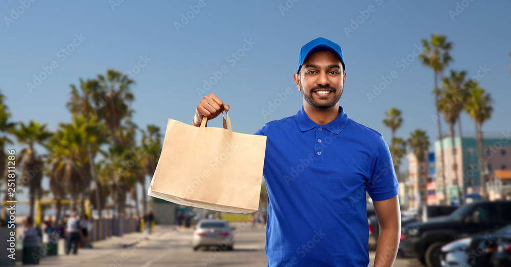 takeaway service and people concept - happy indian delivery man food in ...