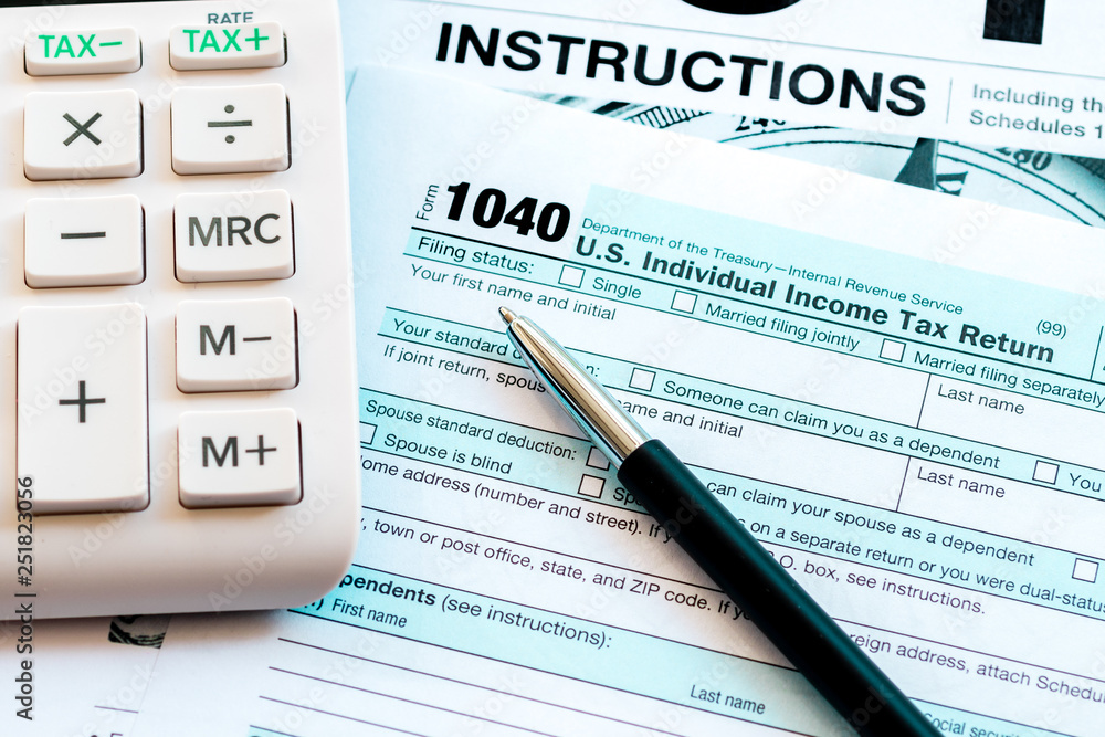 New 2019 IRS 1040 tax form, instructions, pen and calculator Stock ...