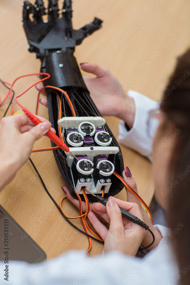 Crop of two female scientist hand, working with voltage and current ...