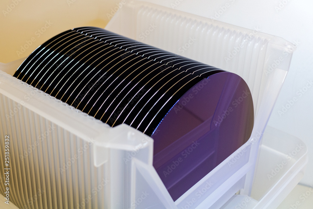 Silicon Wafers in white plastic holder box on a table- A wafer is a ...