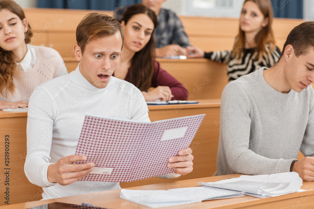Fotografia do Stock: Shocked male student in white sweater with open ...
