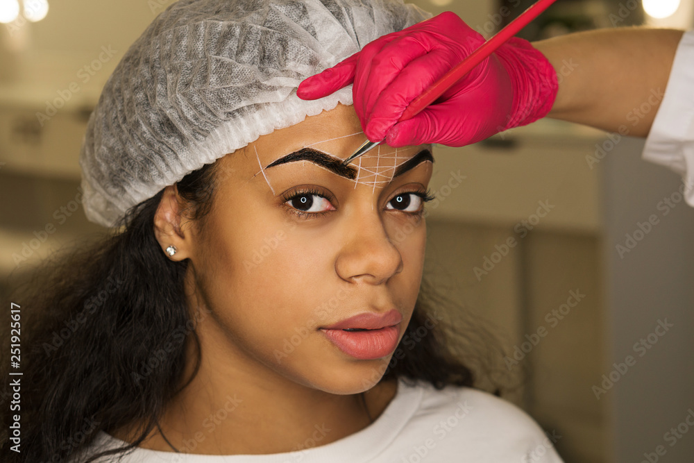 Eyebrow shape correction procedure. Beauty treatment at spa salon ...