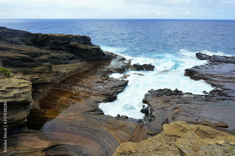 Blue ocean waves hitting rock coast of Hawaii island. close up ...
