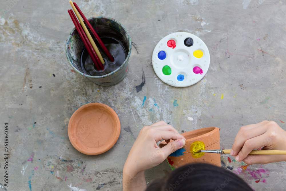 Asian girl studying and learning the art,the kid using paintbrush to ...