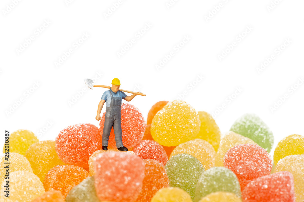 Miniature Worker Working On Gummy Candies With Fruit Juice, Isolated On ...