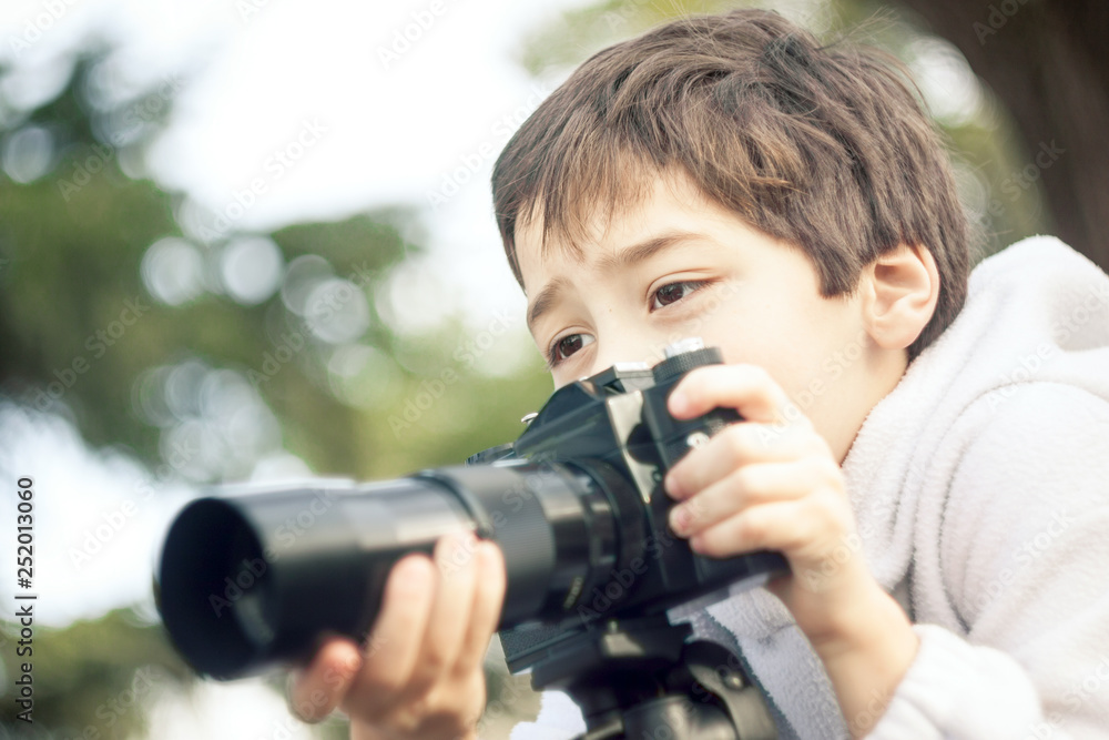 little boy with a camera taking a picture film camera vintage look ...
