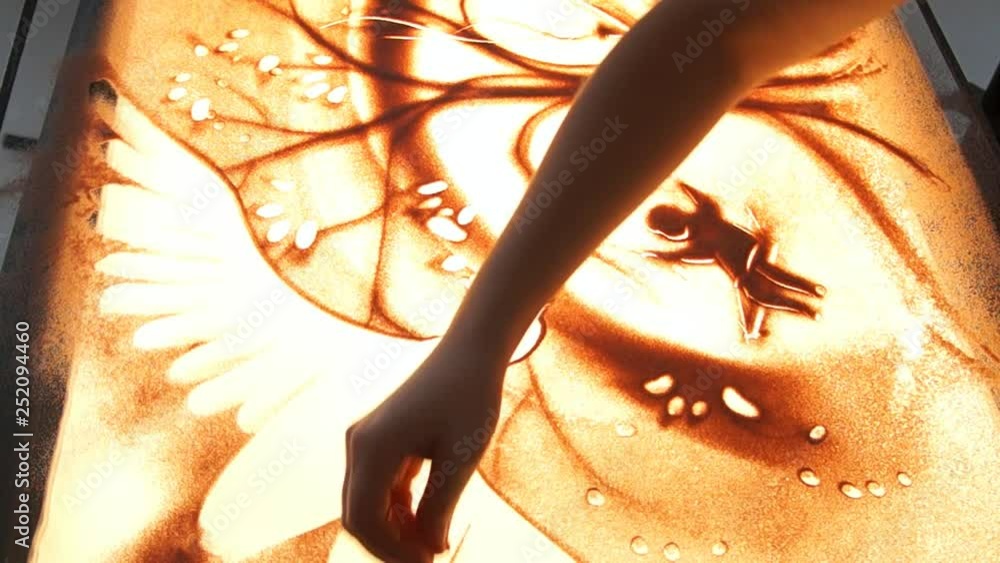 Drawing with sand. Drawing sand on a white screen. Sand Artist. Hands ...