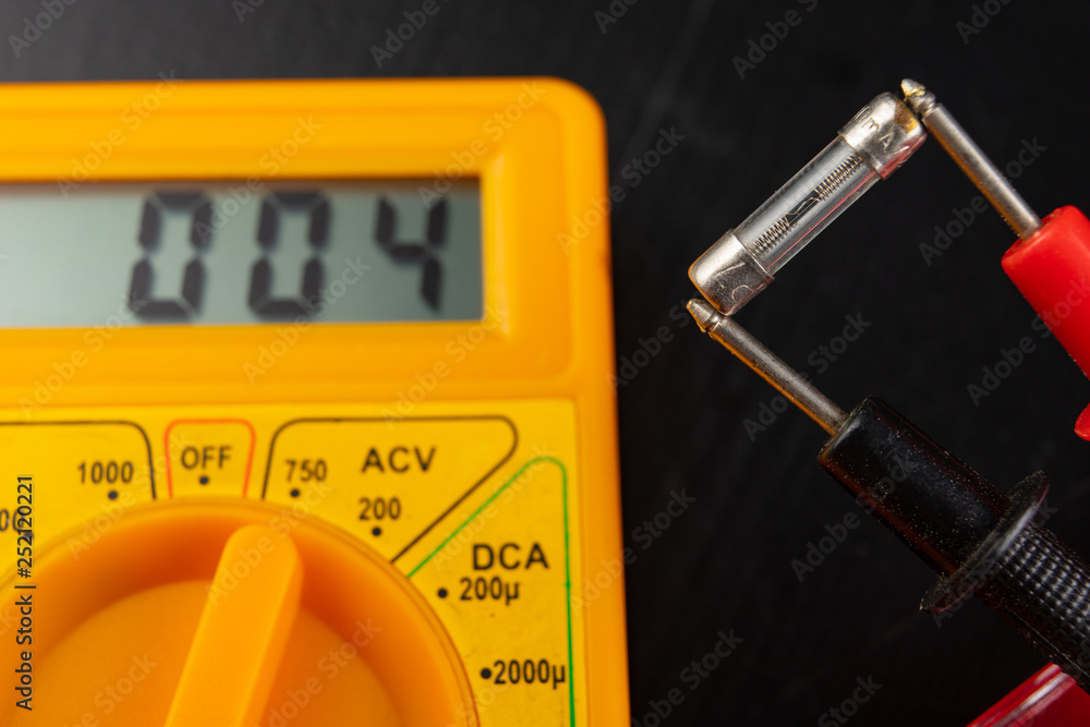 Checking glass fuses using the meter. Simple electrical work in a home ...