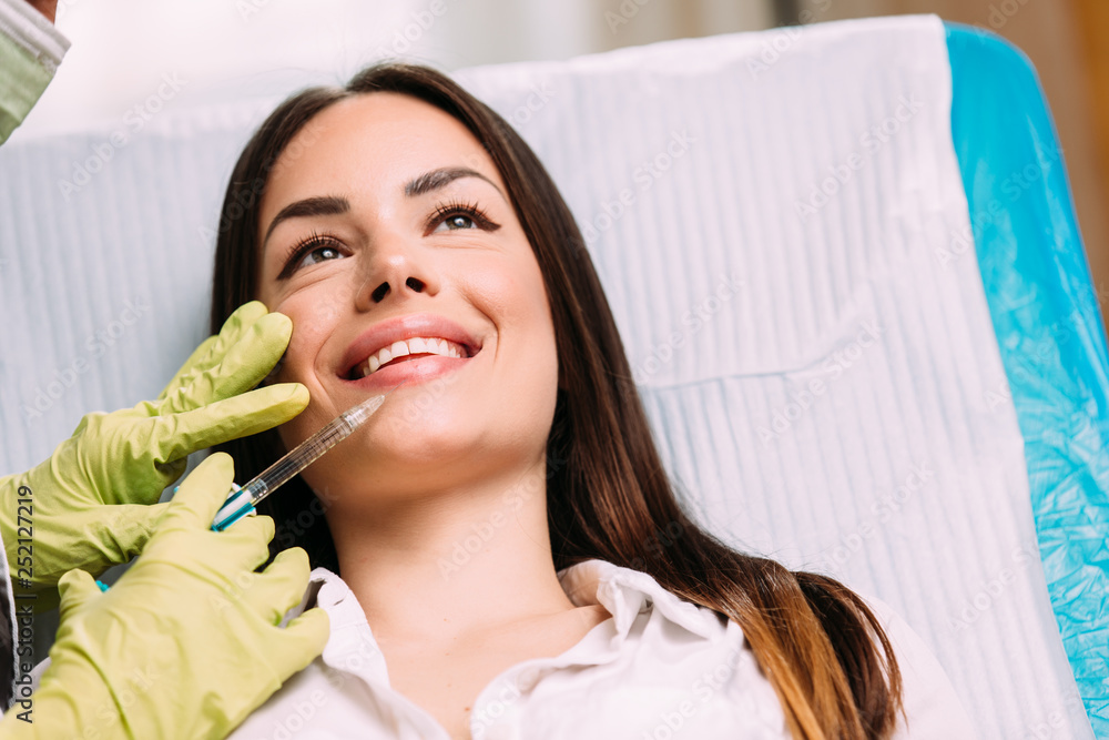 Beautiful young woman gets beauty injection Stock Photo | Adobe Stock