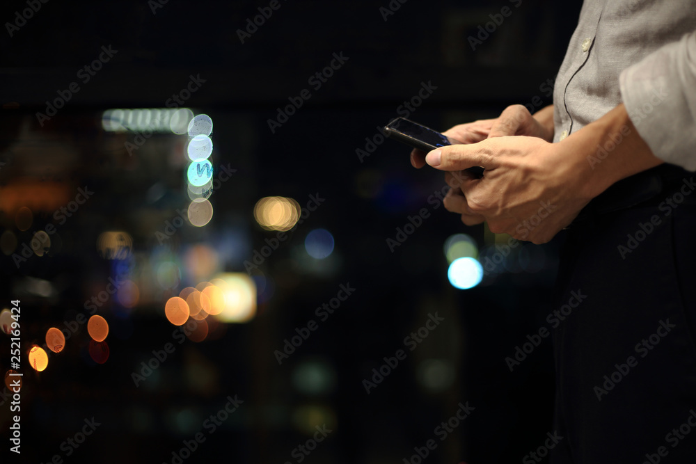 businessman checking on mobile phone in a modern office with out of ...