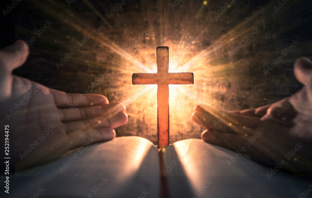 Pray hands with light the cross on bible in worship room. christian praying concept. Stock Photo ...