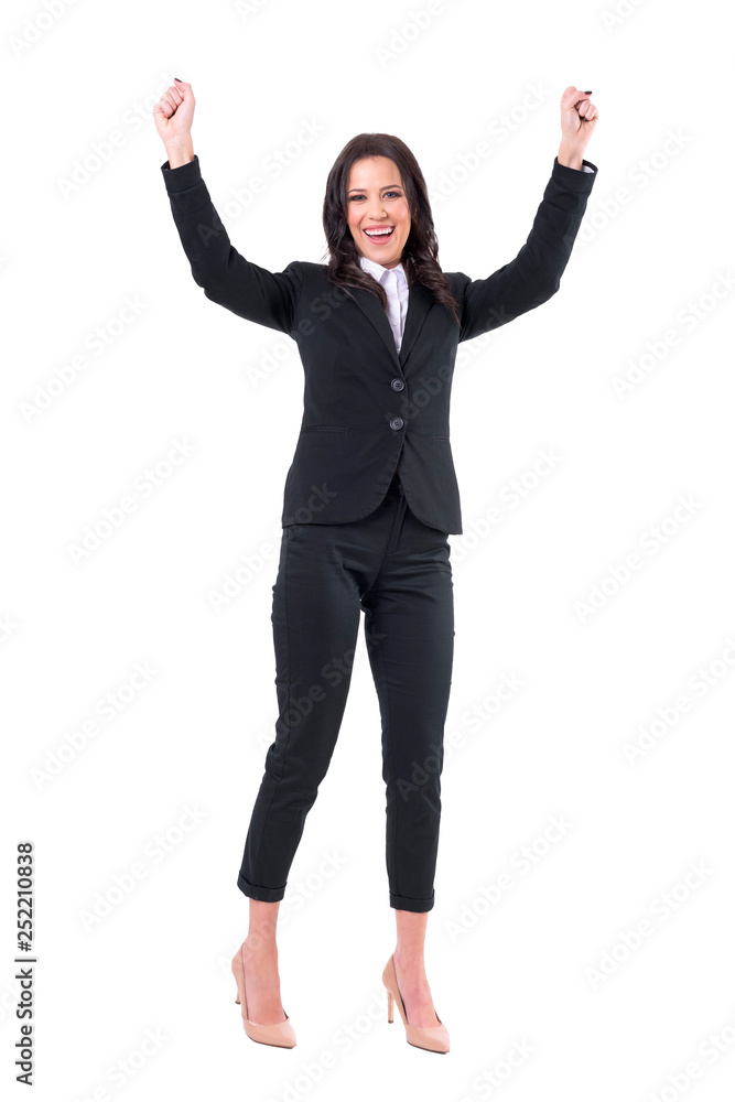 Excited business woman in black formal suit jumping with raised arms ...