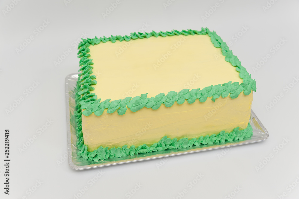 Birthday cake with green and yellow colors. Isolated on white ...