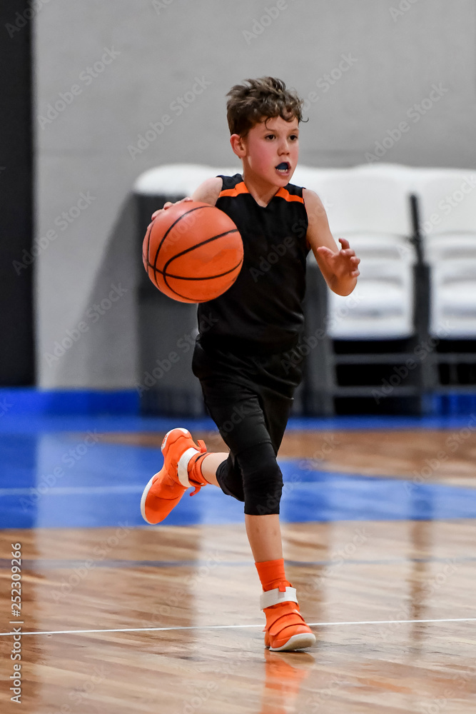 Young boy playing basketball Stock Photo | Adobe Stock