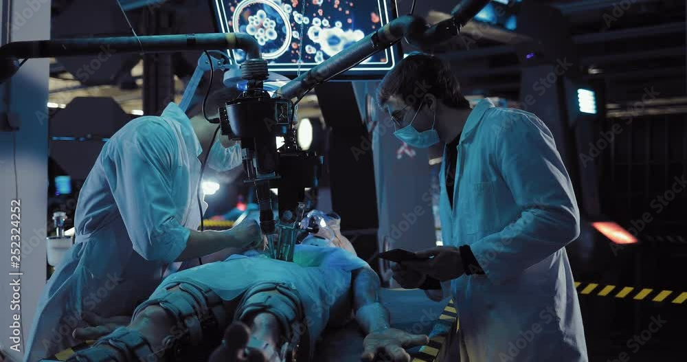 Men scientists conduct an alien operation on a space station. Works ...