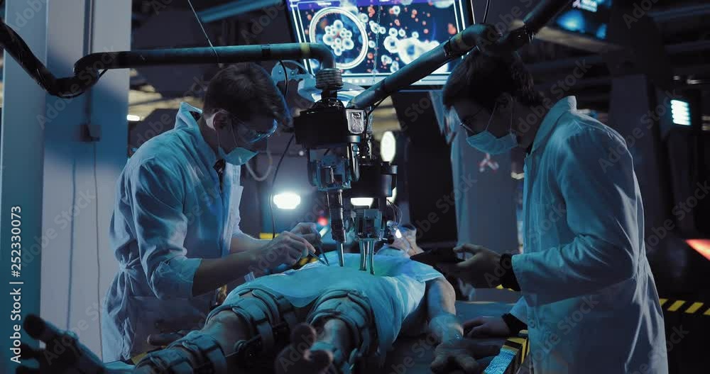 Young scientists surgeons conduct scientific experience on the alien ...