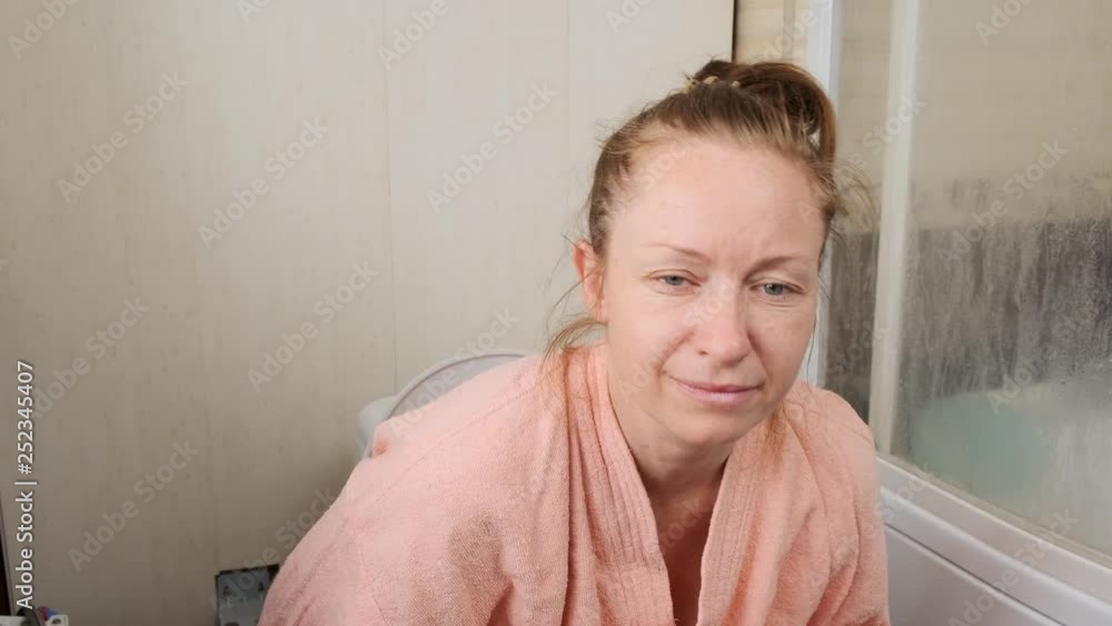 Adult woman sitting on the toilet and straining in the bathroom. Stock ...