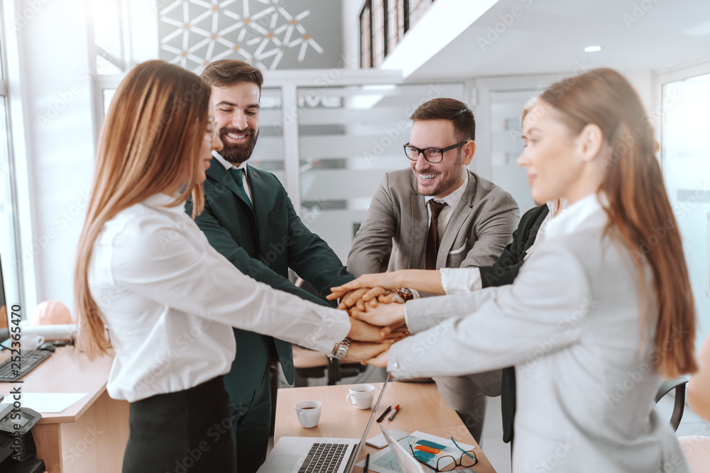 Business people in formal wear stacking hands and smiling. Corporate ...