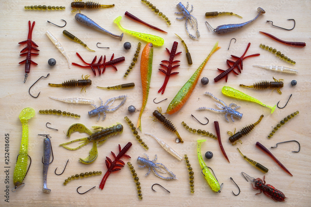 Colorful silicone fishing baits with plummets on wooden table. Various ...
