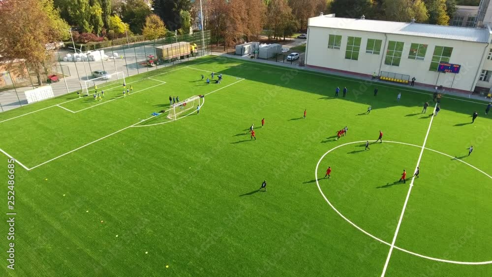 Kids playing football on the stadium Stock Video | Adobe Stock