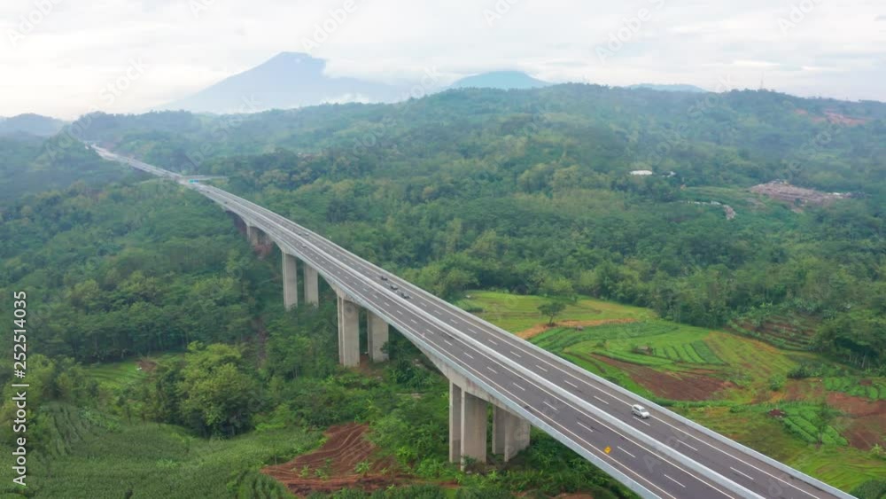 Beautiful aerial scenery of Trans-Java Toll Way bridge and green forest ...