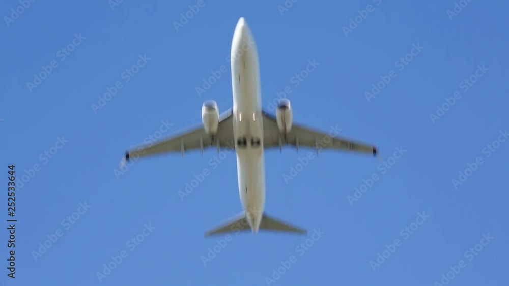 Twin engine jet plane airplane aircraft taking off flying overhead in ...