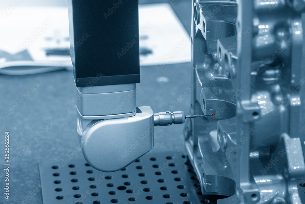 The multi axis CMM machine measure the aluminum automotive part in the ...