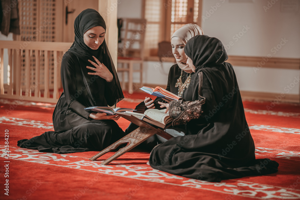 Three muslim girls reading Quran in mosque Stock Photo | Adobe Stock