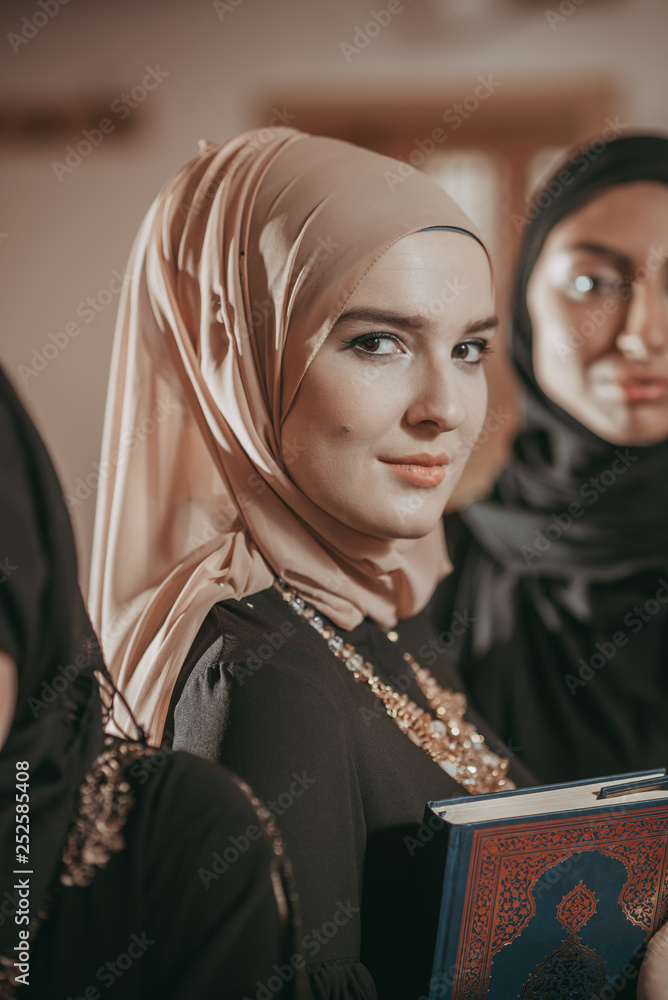 Three muslim girls reading Quran in mosque Stock Photo | Adobe Stock