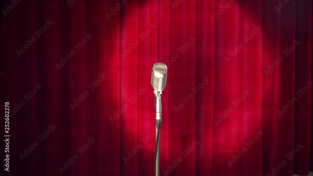 Retro microphone over the red curtain background, vintage musical ...