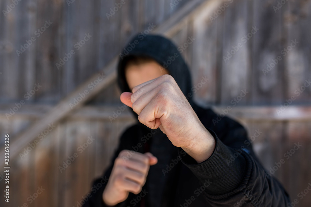 Unidentifiable teenage boy attacking with hes bare hands, focus on the ...
