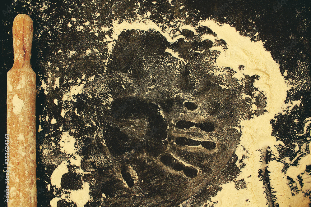 cooking baking. patterns of flour on a black background. rolling pin ...