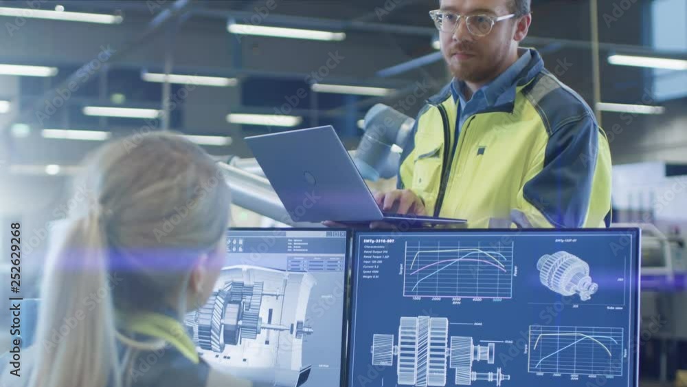 At the Factory Male and Female Mechanical Engineers Working on New ...