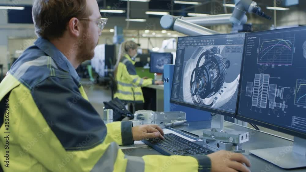 Stockvideo At the Factory: Male Mechanical Engineer and Female Chief ...