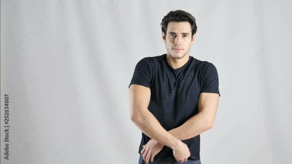 Fit athletic young man removing t-shirt on naked muscular pecs, abs and ...