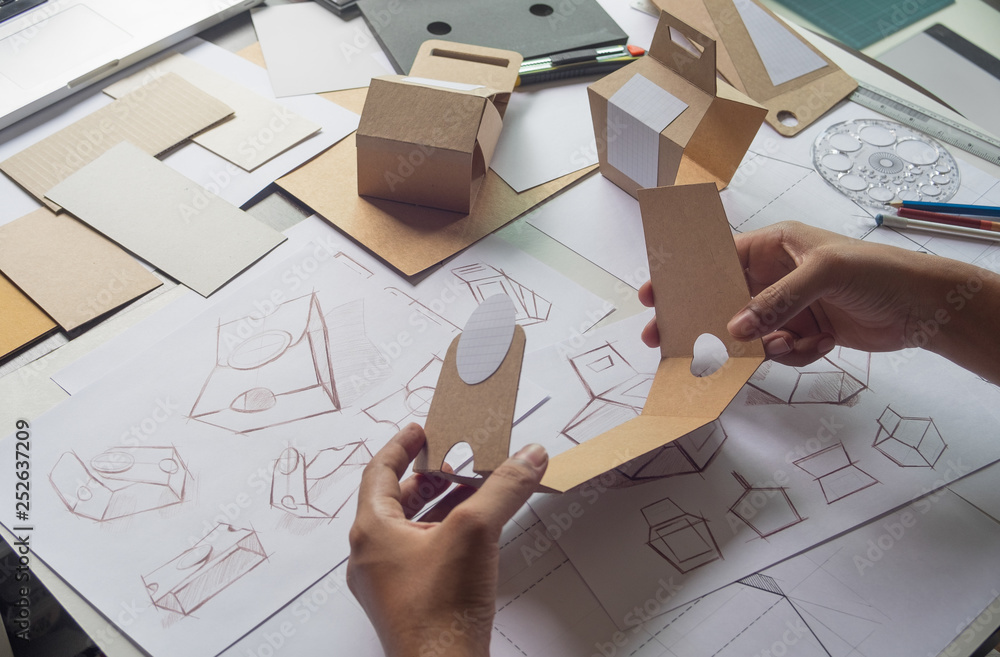 Designer sketching drawing design Brown craft cardboard paper product ...