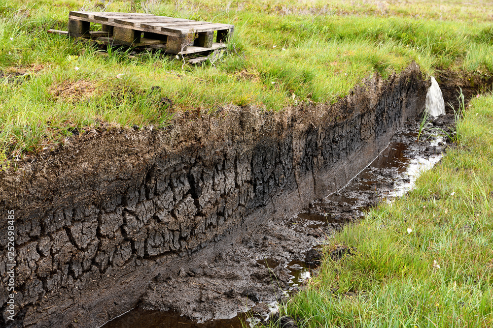 Trench cut into deep Peat of wetland moors on Isle of Skye Scotland to ...