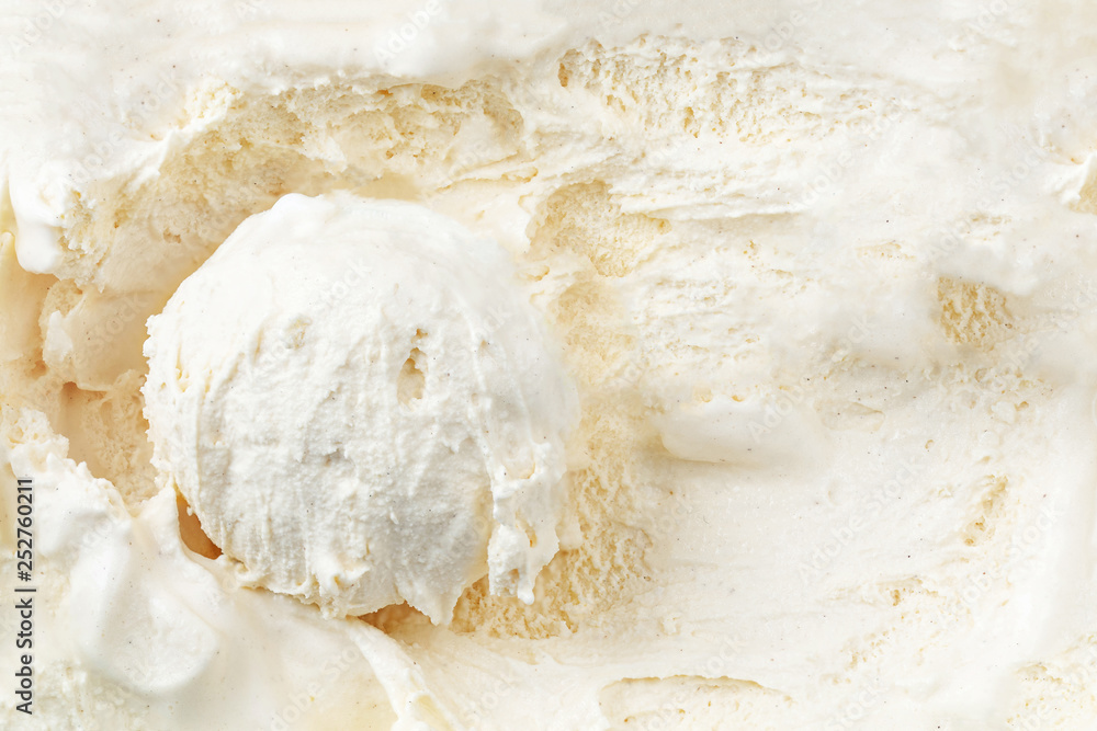 Vanilla ice cream with a scoop in container as background. Macro ...
