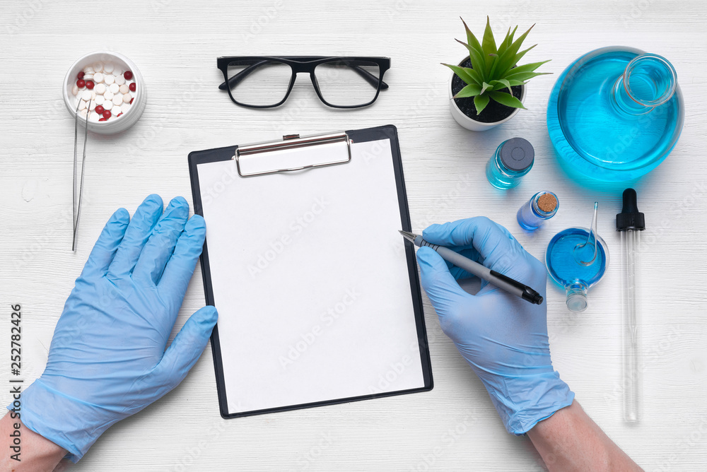 Medical examination mockup. A doctor or pharmacist is writing a notes ...