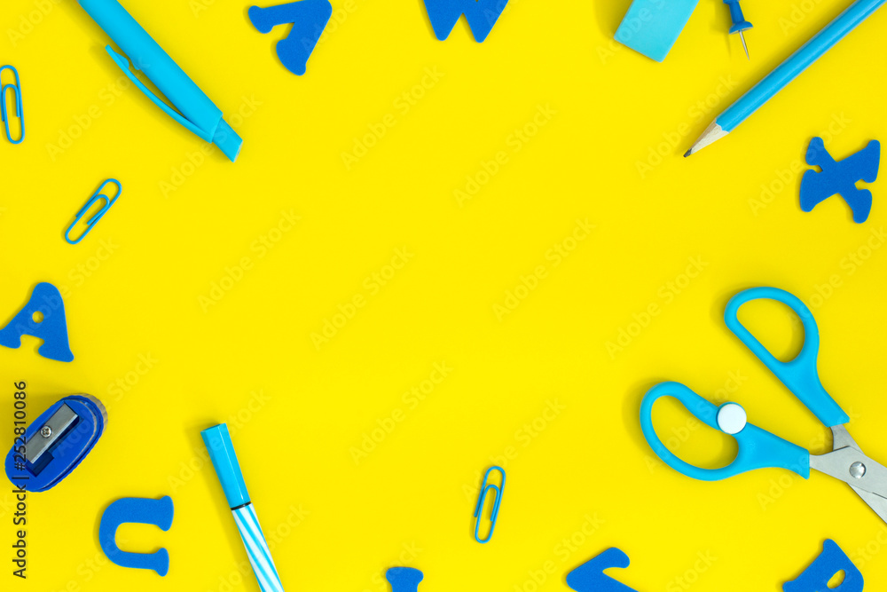 Blue school supplies on a yellow desk.Back to school background Stock ...