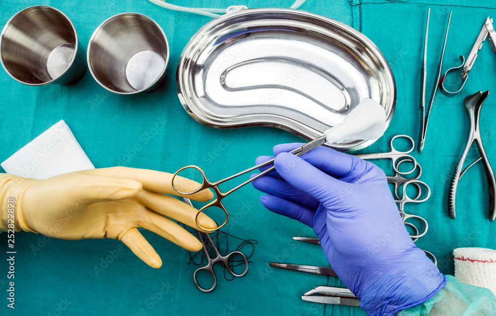 Surgeon working in operating room, hands with gloves holding scissors ...