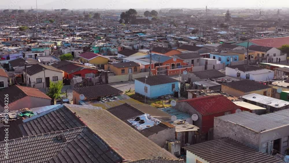 Aerial over Gugulethu, one of the poverty stricken slums, ghetto, or ...