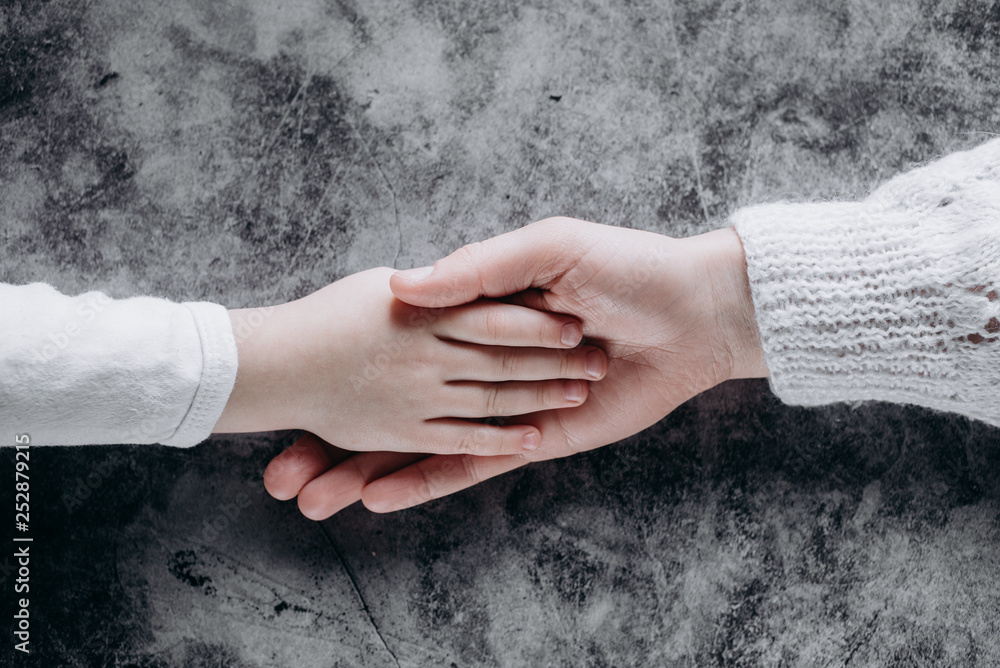 Close up view of family holding hands, loving caring mother supporting ...